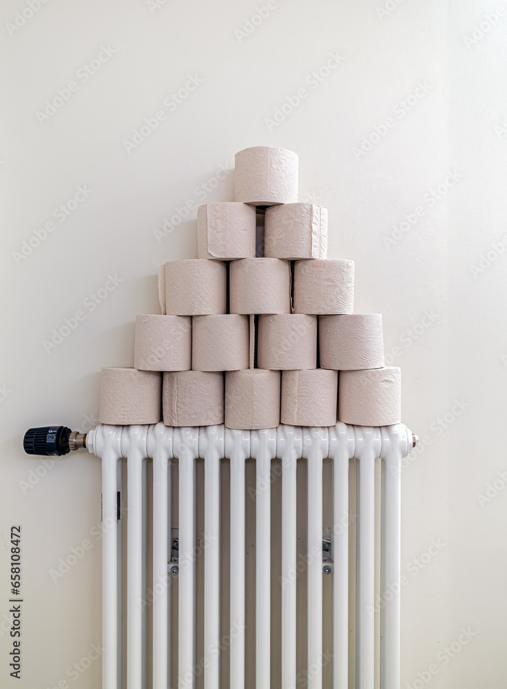 Toilet paper stacked in a triangular shape on a radiator Stock Photo ...