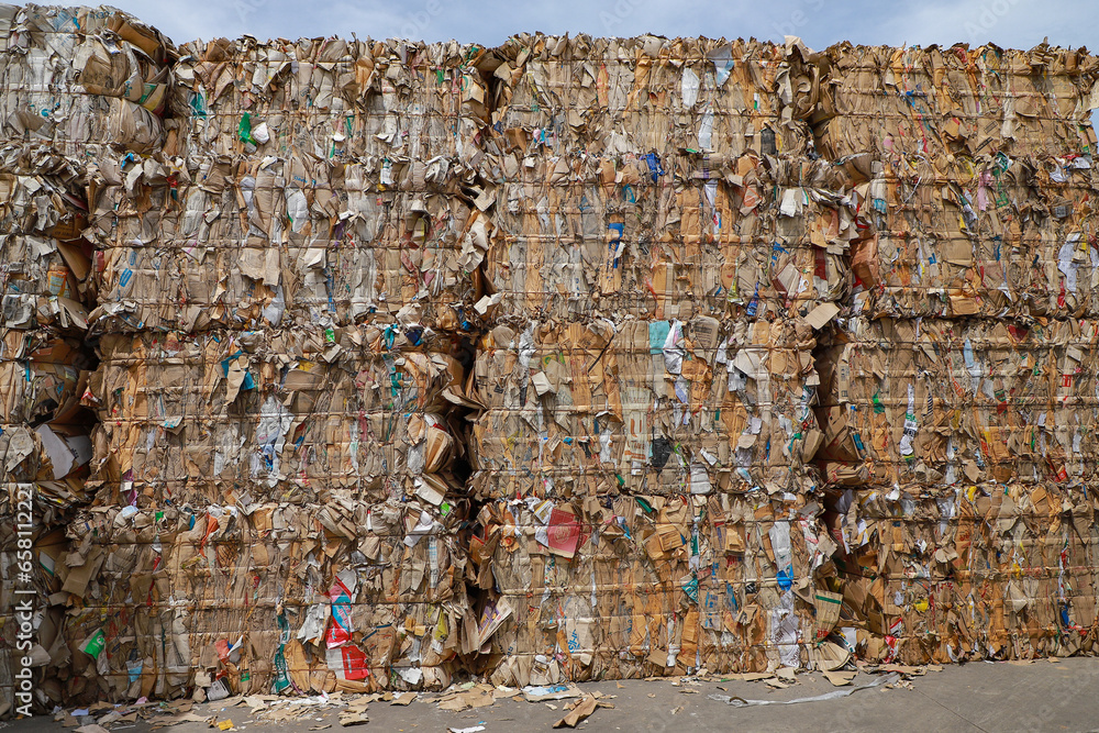 Bales of cardboard and box board with strapping wire ties before ...