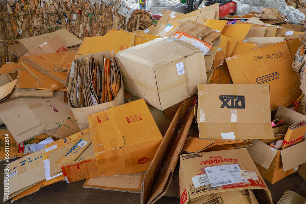 Bales of cardboard and box board with strapping wire ties before ...