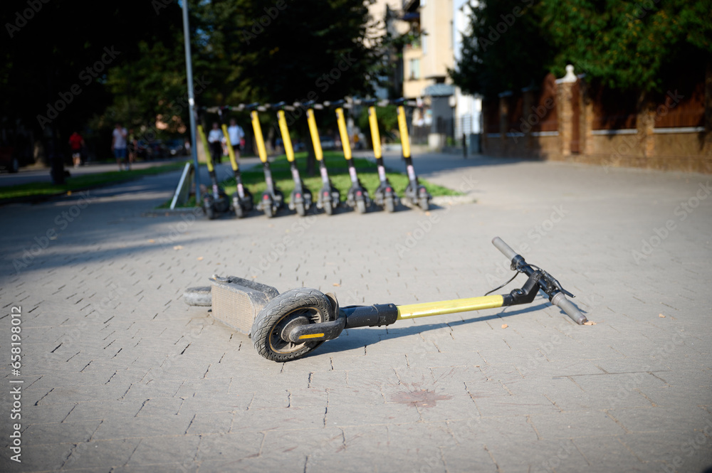 Broken electric scooter lies on the road. Rent a scooter. Urban ...
