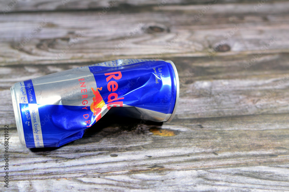 Cairo, Egypt, October 1 2023: Crushed dented Red Bull energy drink, a ...