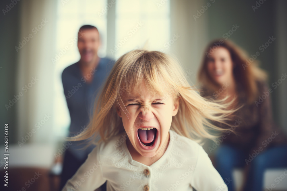Portrait of angry little girl screaming in front of her parents at home ...