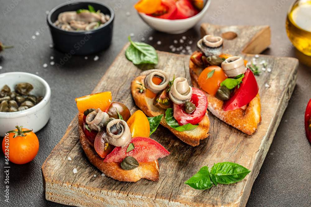 Toast tapas with anchovies, tomato on bread. Traditional italian ...
