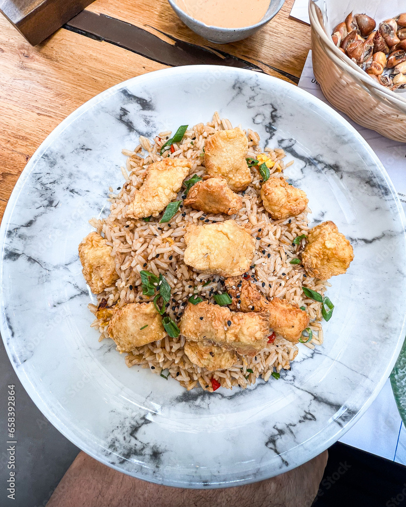 Peruvian traditional food chaufa rice with Fried Fish and spices ...