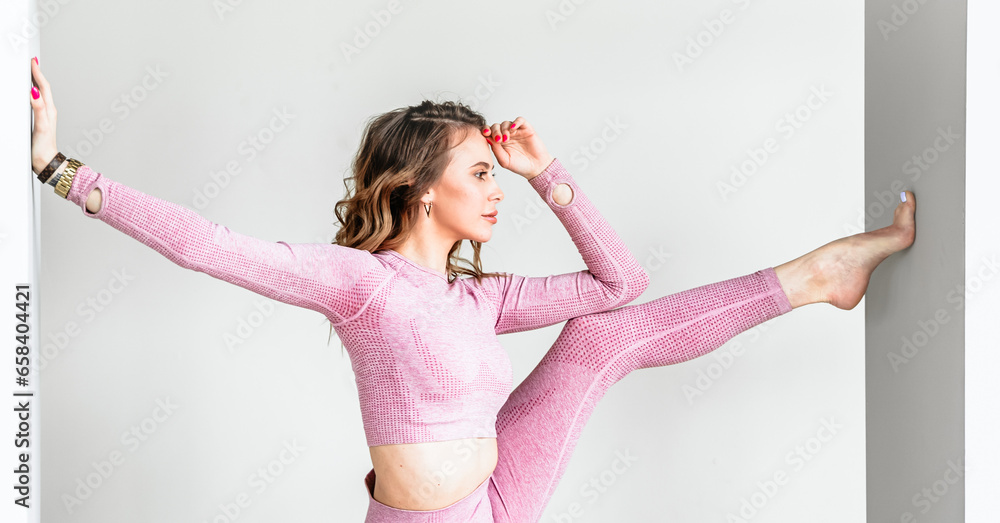 Slim woman training yoga poses, asanas in pink tight-fitting tracksuit ...