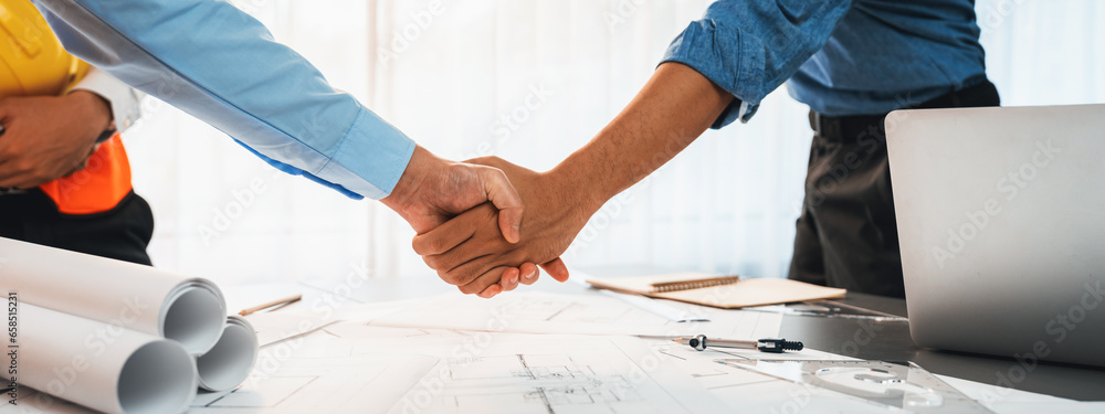 Construction engineer handshake with businessman contractor over ...