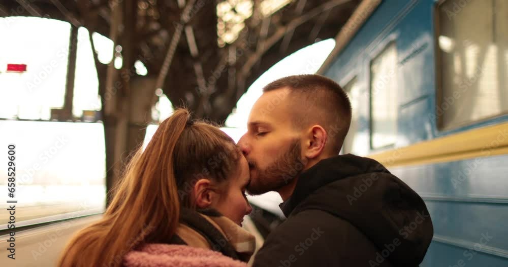 A young couple in love hug and say goodbye before the girl gets on the ...
