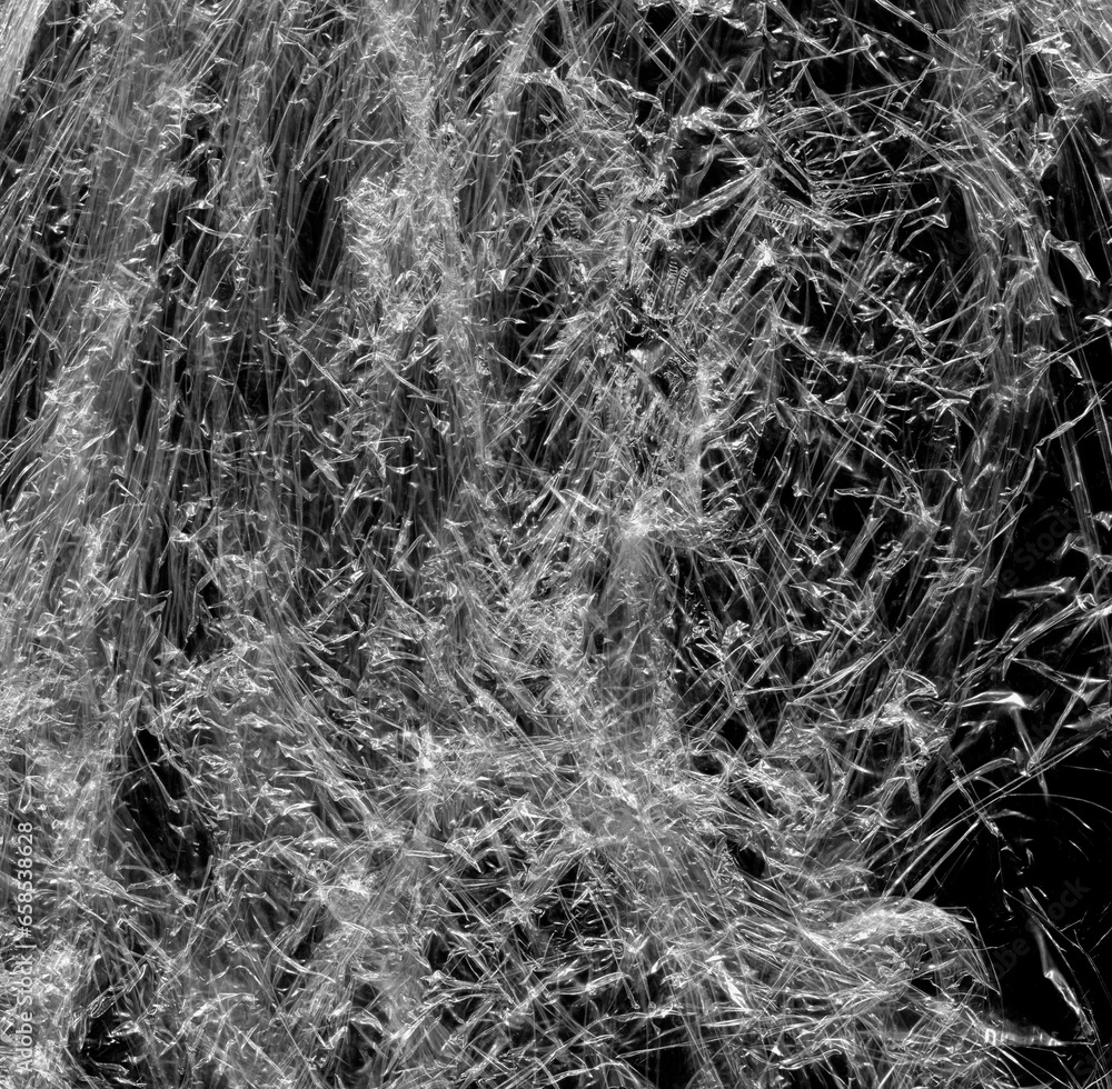 Wrinkled plastic wrap texture on a black background wallpaper. Royalty ...