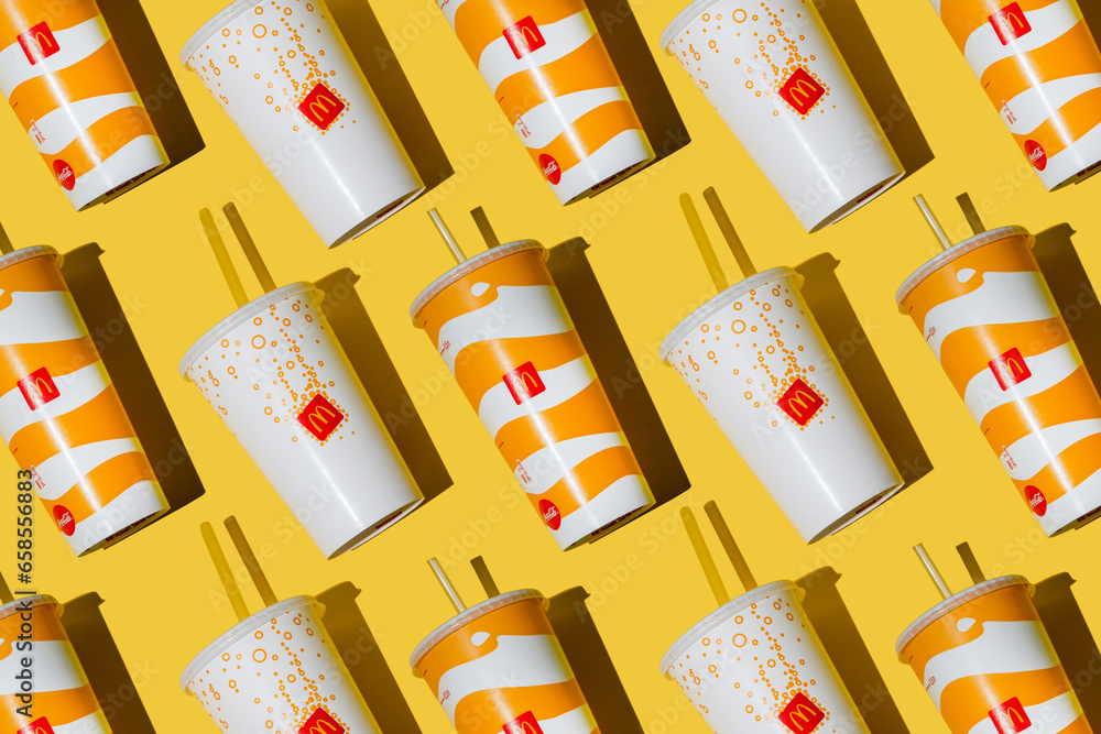 Yellow glass of McDonald's. Paper cup with lid. Takeaway drink ...