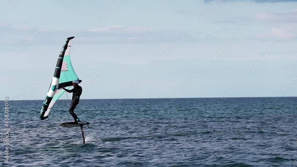 Modern water sport. Hydrofoil ride on the ocean using the wing and the ...