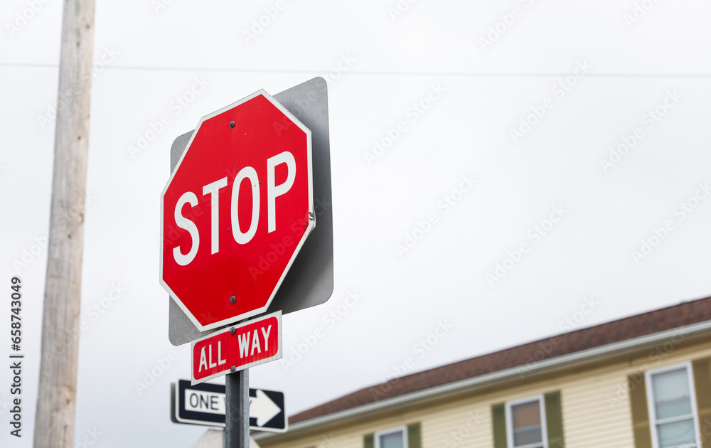 red stop sign on urban street corner, symbolizing road safety and ...