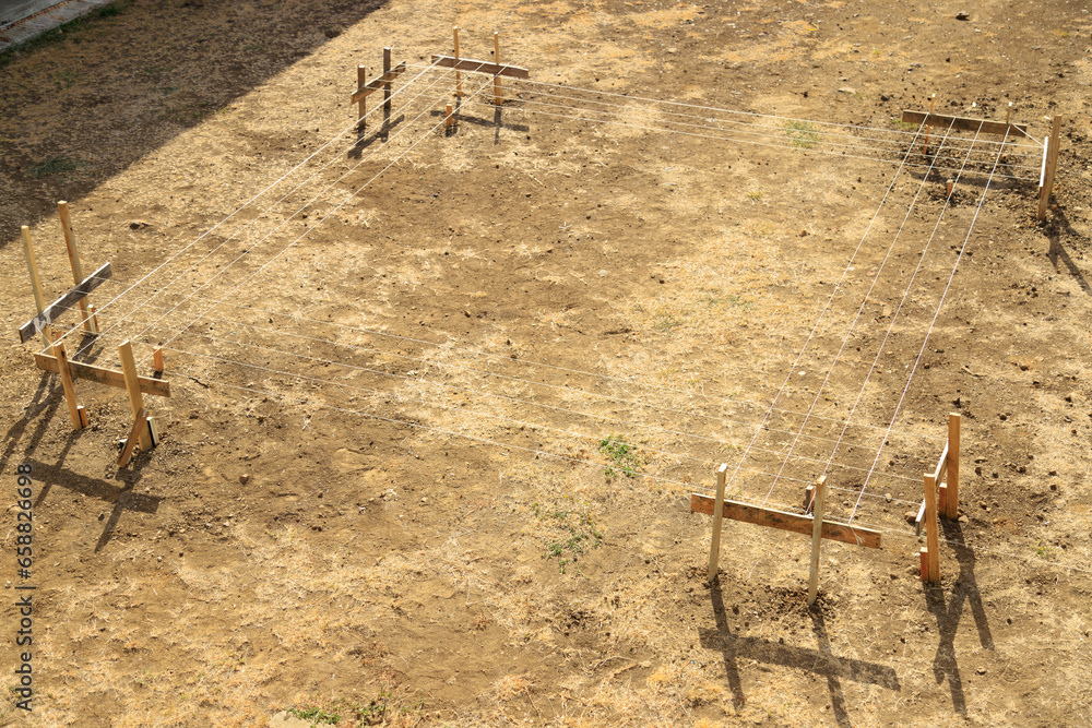 laying out the shape of a rectangular building on the ground with ...