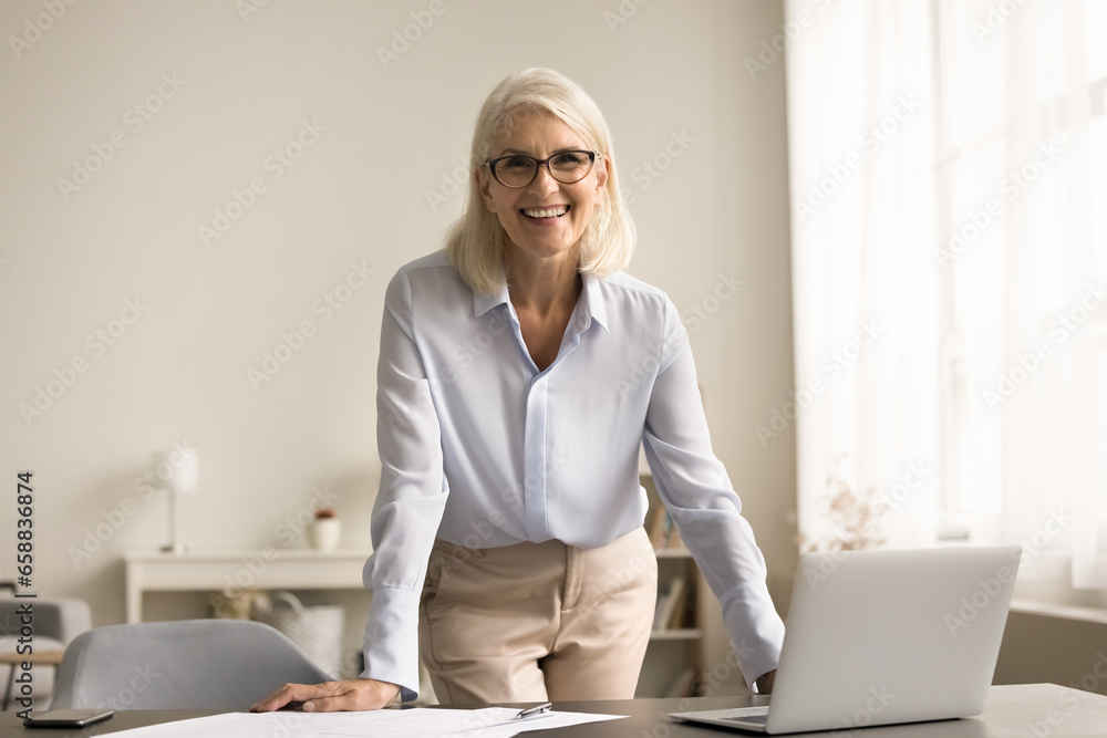 Happy old business woman in elegant glasses and clothes standing at ...