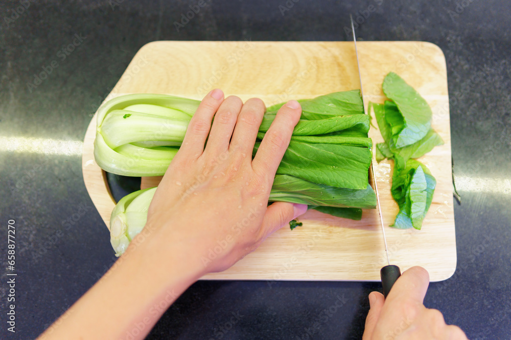 Woman hands cutting fresh green bok choy (pak choy) Stock Photo | Adobe ...