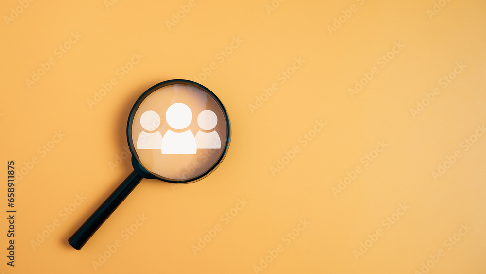 Customer group icons in a magnifying glass placed on a yellow ...