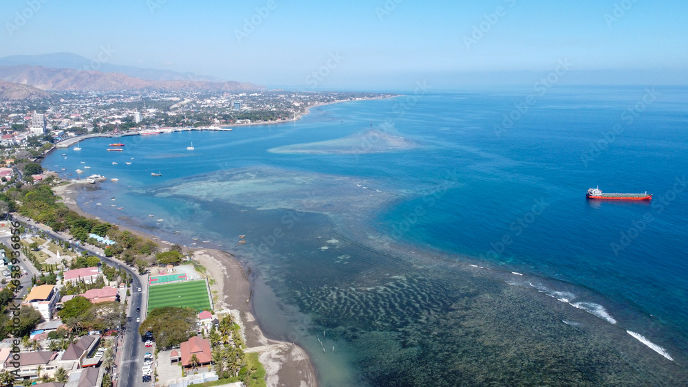 Scenic aerial of coastal capital city of Dili in Timor-Leste with views ...