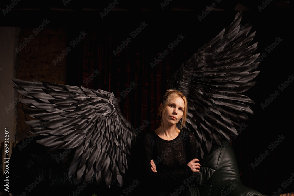A woman with black angel wings is a symbol of the dark side of human ...