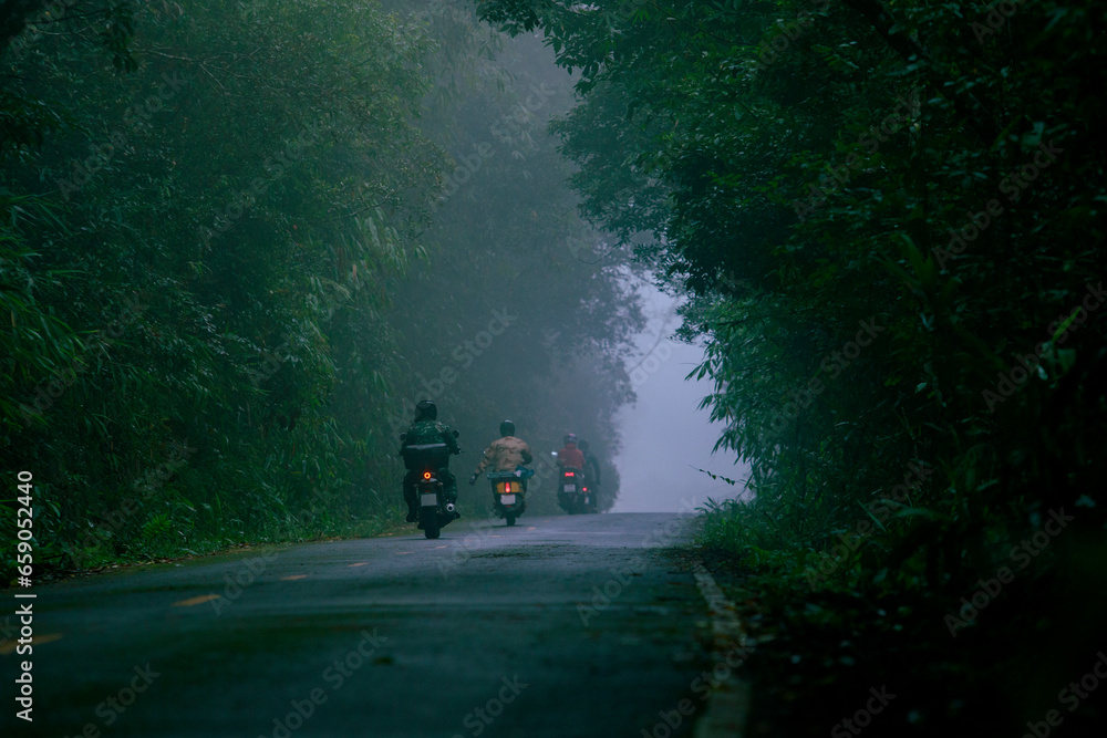 Poster group of biker riding on foggy mountain road at khaoyai national ...