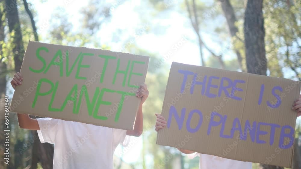 Sunny day in the woods, children with signs protesting climate change ...