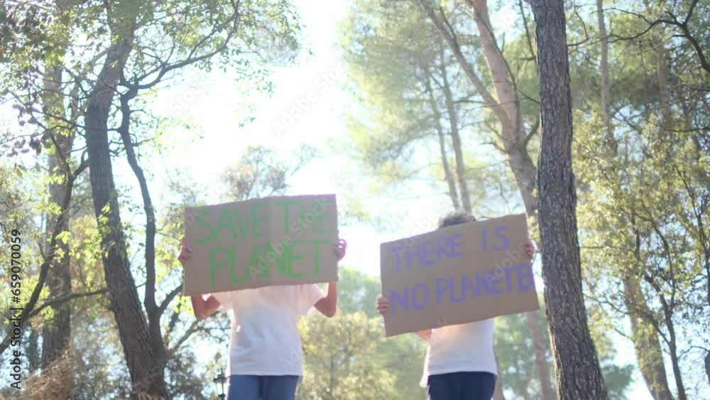 Sunny day in the forest, children with signs protesting climate change ...