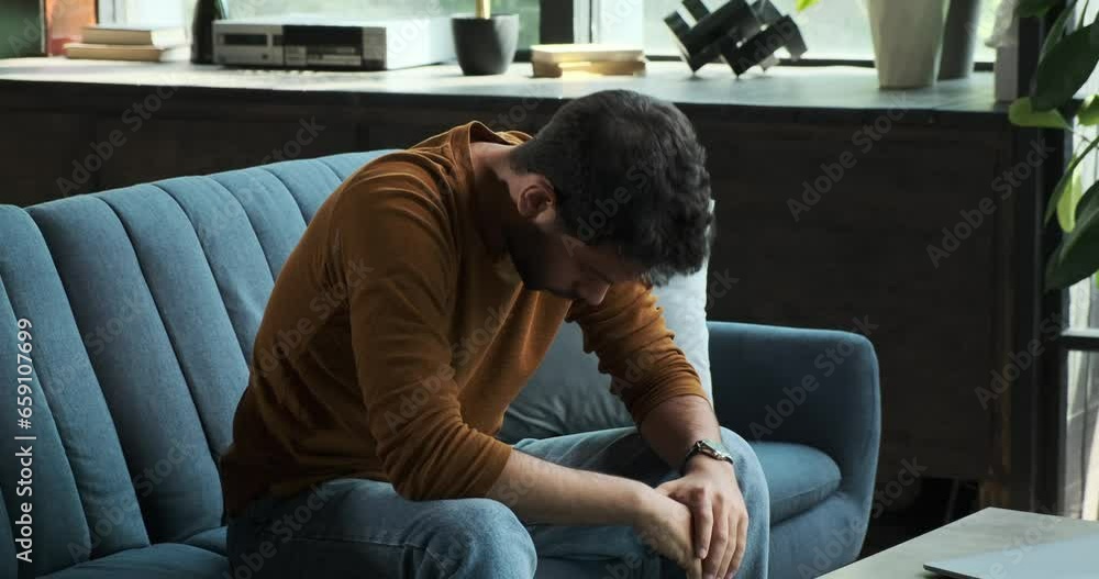 Middle Eastern man with a melancholic expression experiences a moment ...