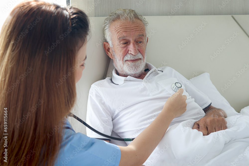 Elderly man feels sick and rest in bed at home with caring female nurse ...