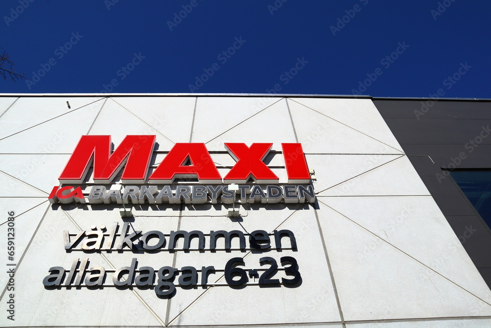 Entrance and exit of a grocery store. Ica Maxi sign on a large wall ...