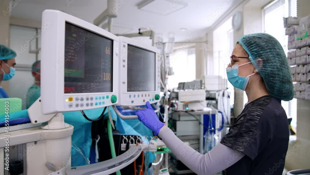 Female doctor wearing glasses is focused on the screens of lung ...