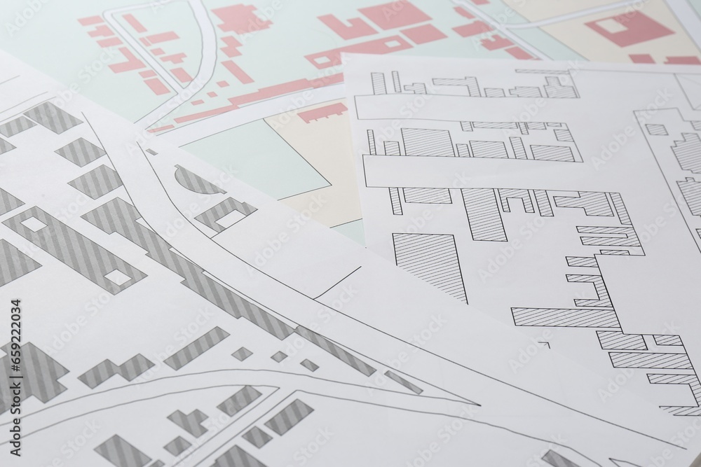 Many different cadastral maps of territory with buildings as background ...
