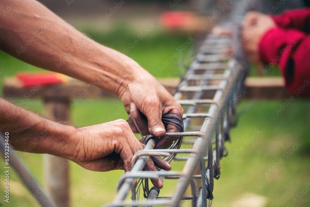 Men hands using pincer pliers iron wire reinforcement of concrete work ...