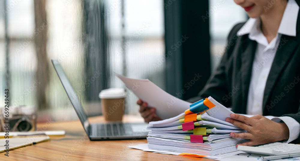 Businesswoman hands working in Stacks of paper files for searching and ...