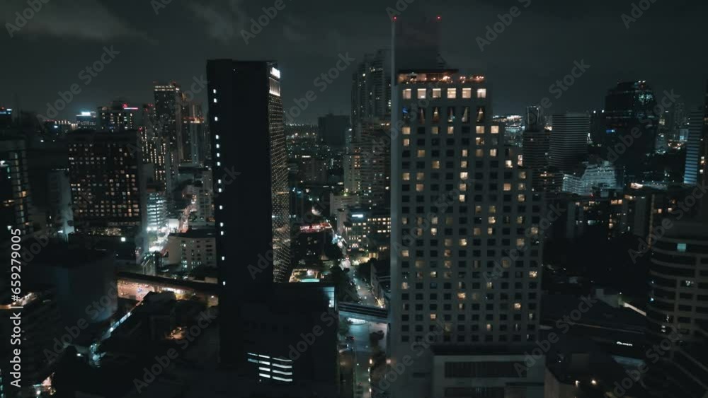 Drone flying at night city with skyscrapers. Urban skyline captured by ...