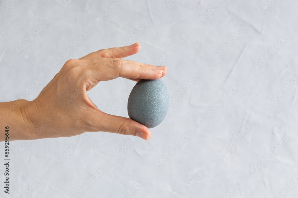 Gel hand grip ball egg in woman hand. Fitness wrist, fingers mobility ...