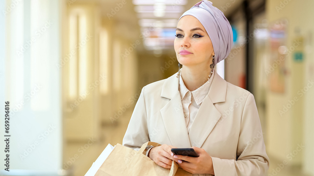 Muslim businesswoman walks past departments scrolling social media on ...