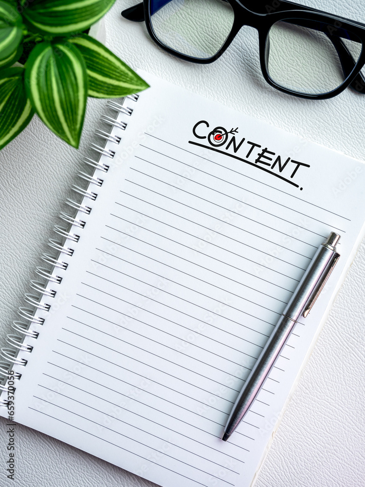 Content, handwriting text and target icon on blank notepad page with ...