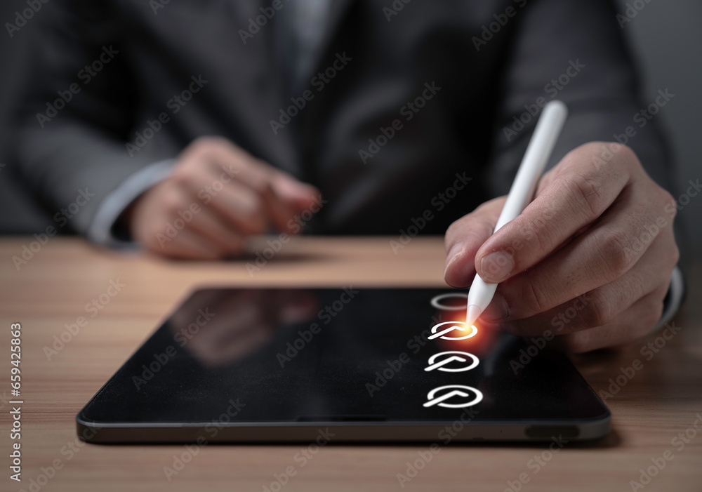 Businessman using electronic pen to tick approve on tablet for ISO ...