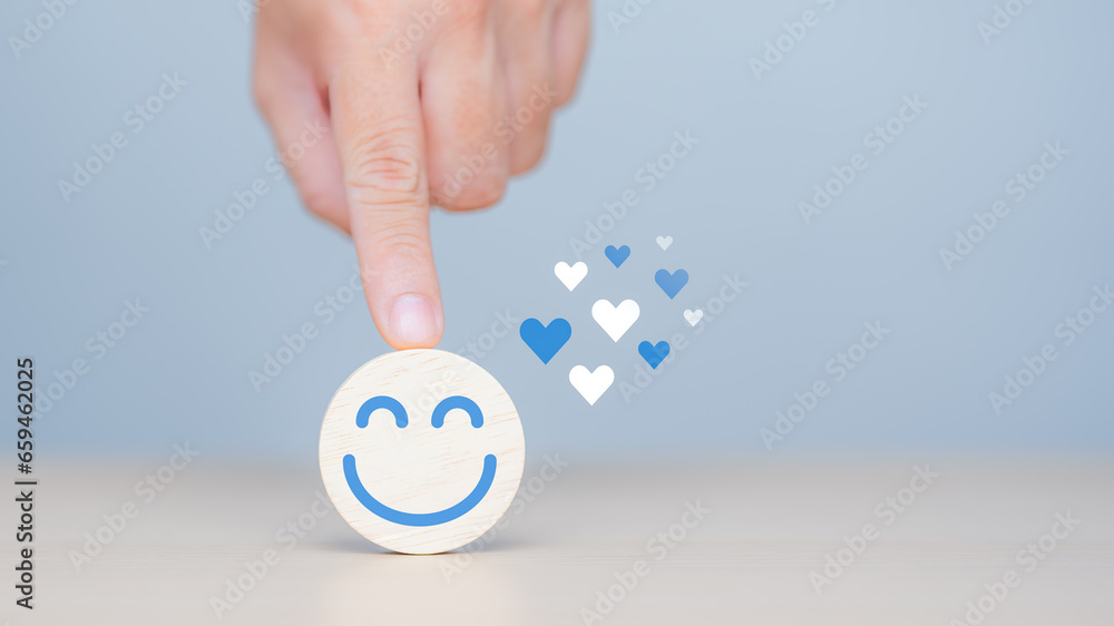 Foto Stock Hand with happy smiley face emotion on wooden circle ...