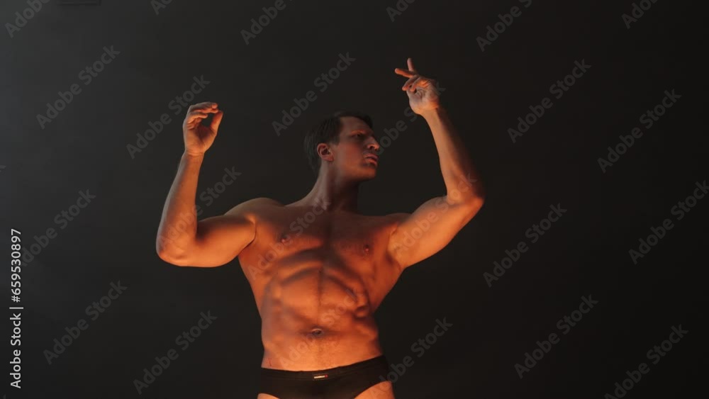 A muscular athlete in an epic pose, fog and smoke on the background ...