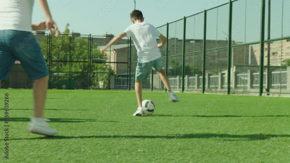 Group of boys playing football on sport playground in sunny day . Many ...