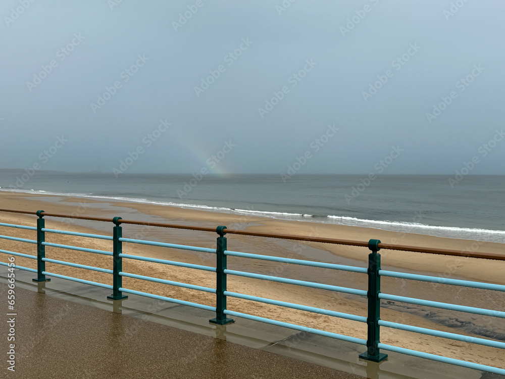 Retro seaside mint coloured handrail at walkway or promenade at the ...