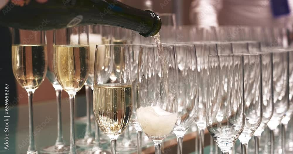 Waiter is pouring champagne. Pour the champagne into a glass. Champagne ...