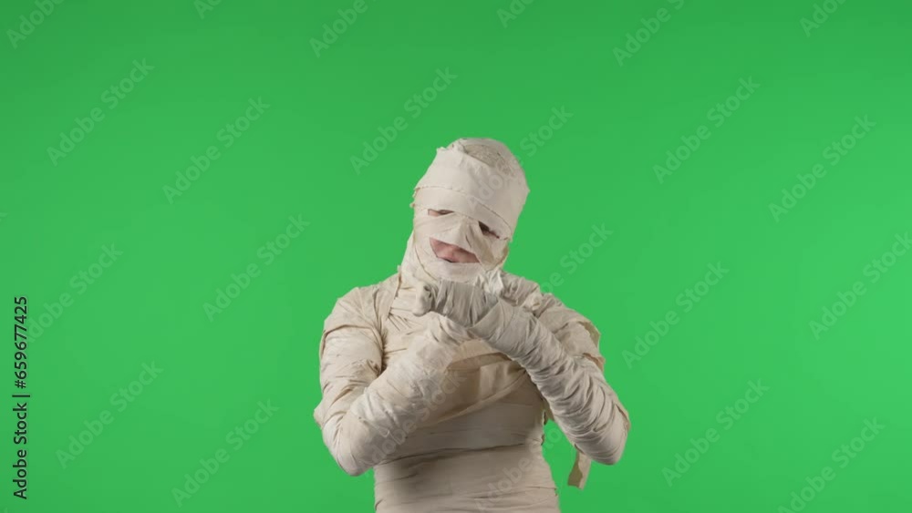Green screen isolated chroma key video capturing a mummy standing with ...