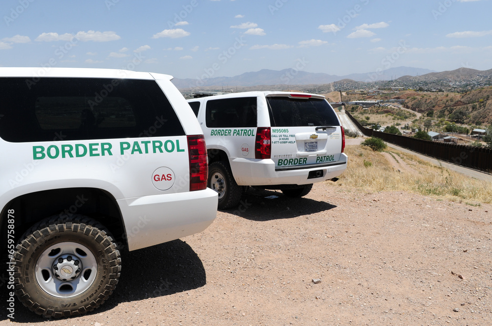 Border Patrol vehicles stationed near the Mexico–United States border ...