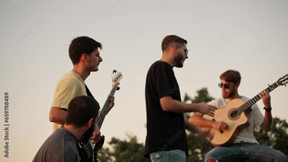 Group of Friends playing music during their band rehearsal outside ...