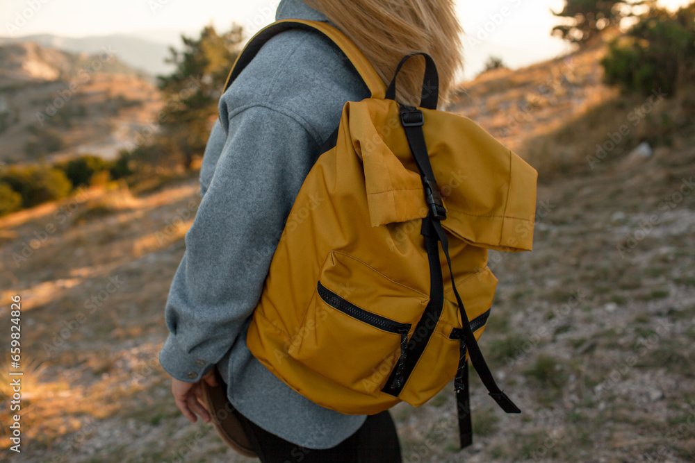 Back view of the plus size woman walks in the mountain. The gil admires ...