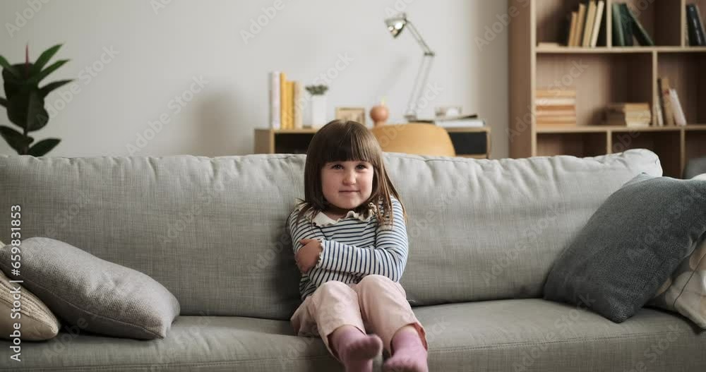 Offended Caucasian Girl Sits On The Living Room Couch Crossed Arms In