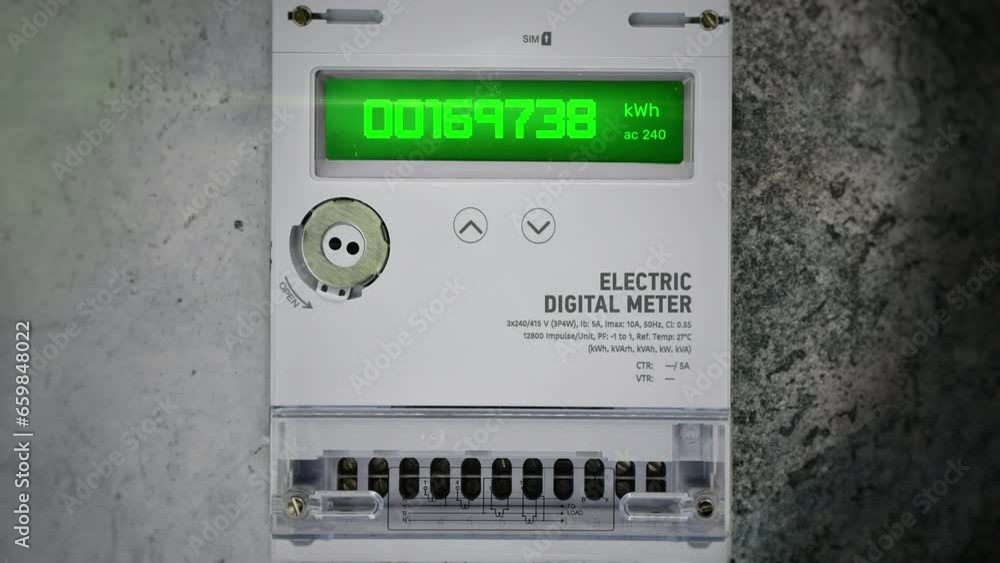 Electric digital meter mounted on the wall, showing residence energy ...