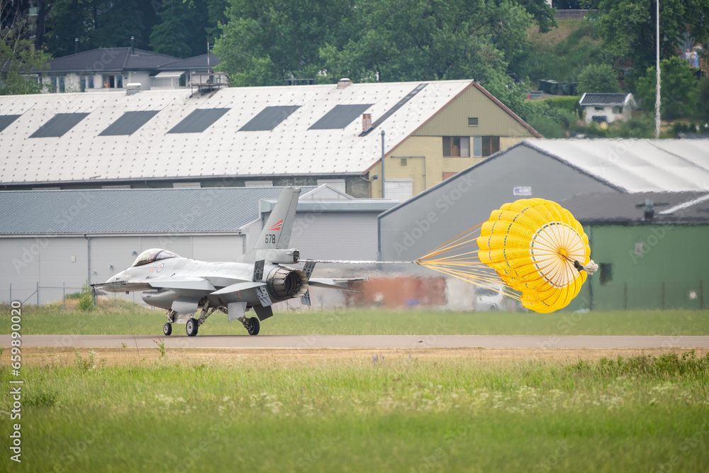 f-16 fighter jet during landing with yellow parachute braking. Stock ...