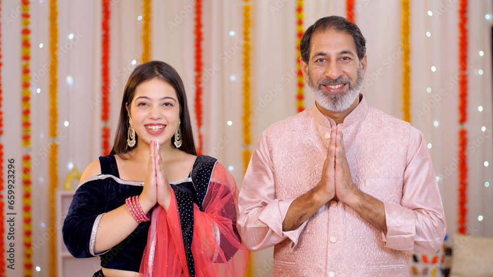 Father and daughter greeting people on Diwali - Indian culture Namaste ...