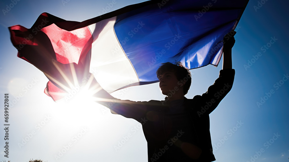 patriotic young man holding the flag against a golden sun backdrop ...